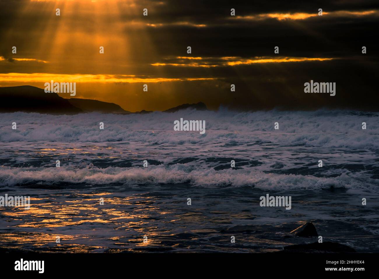 Crepuscular rays of a dramatic sunset over Fistral Bay in Newquay in ...