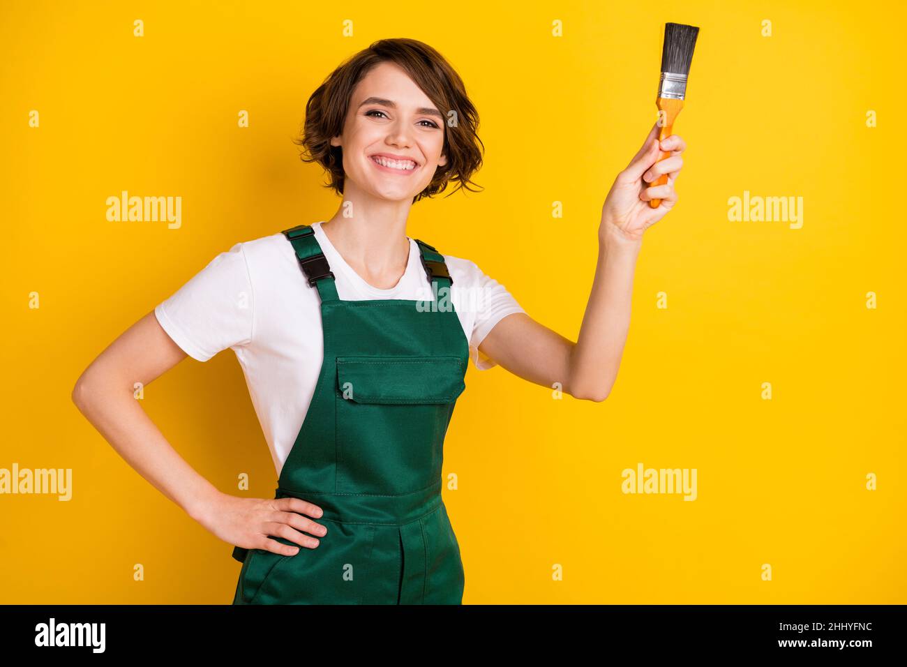 Photo of optimistic nice brown hair lady hold brush wear uniform ...