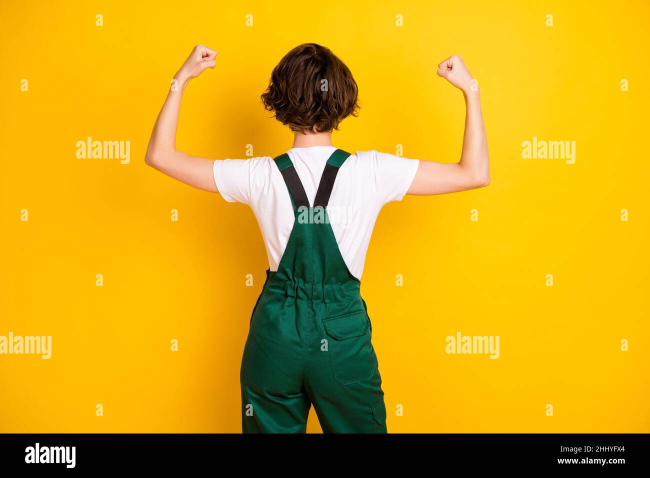 Back view photo of beautiful strong powerful woman builder constructor ...