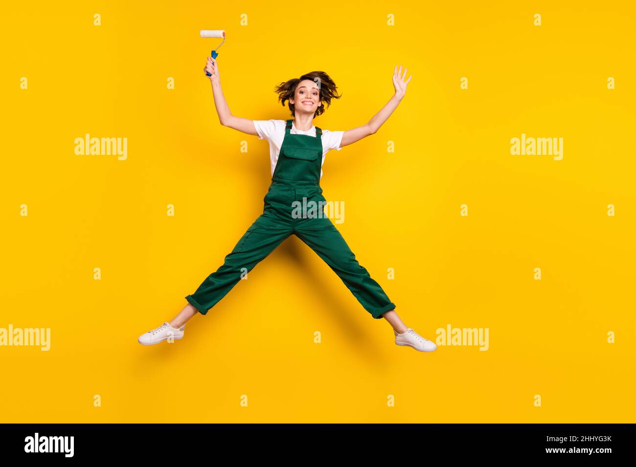 Full size photo of happy excited good mood girl painter hold roller ...