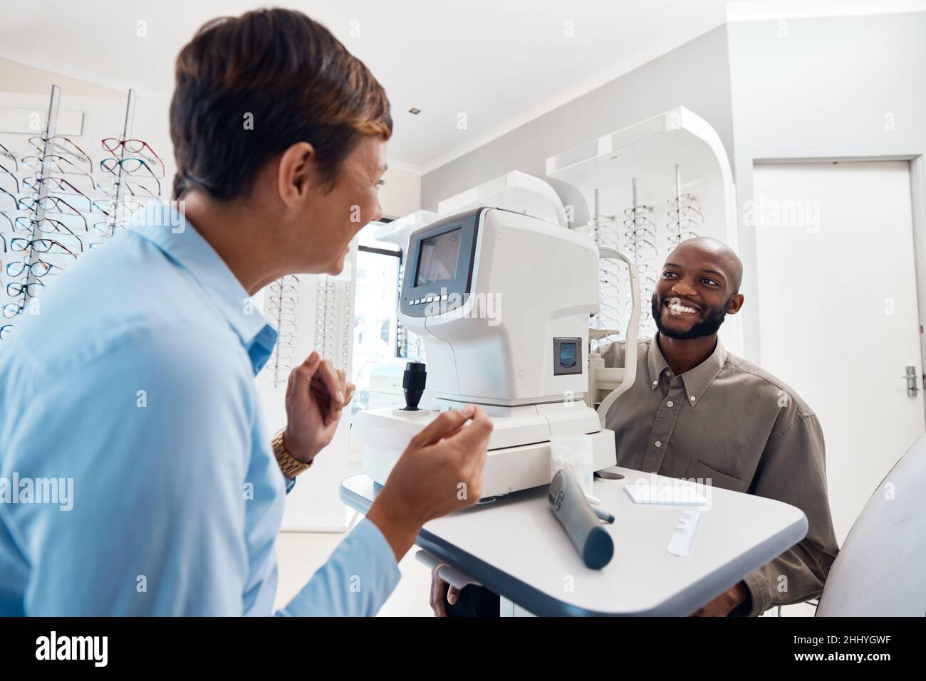 Your vision is better than ever. Shot of an optometrist examining her ...