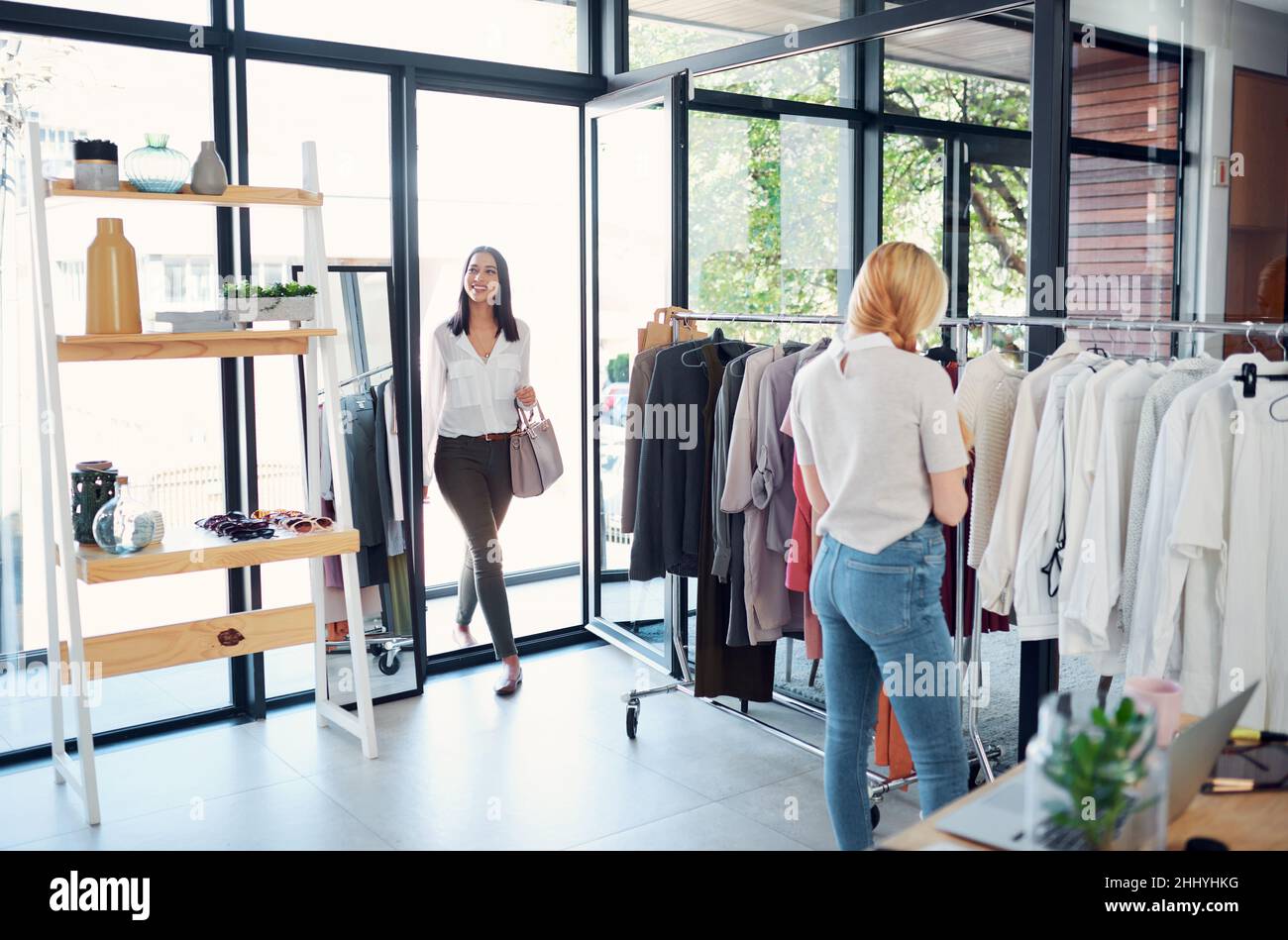 Checking out the new boutique. Shot of two young women shopping in a ...