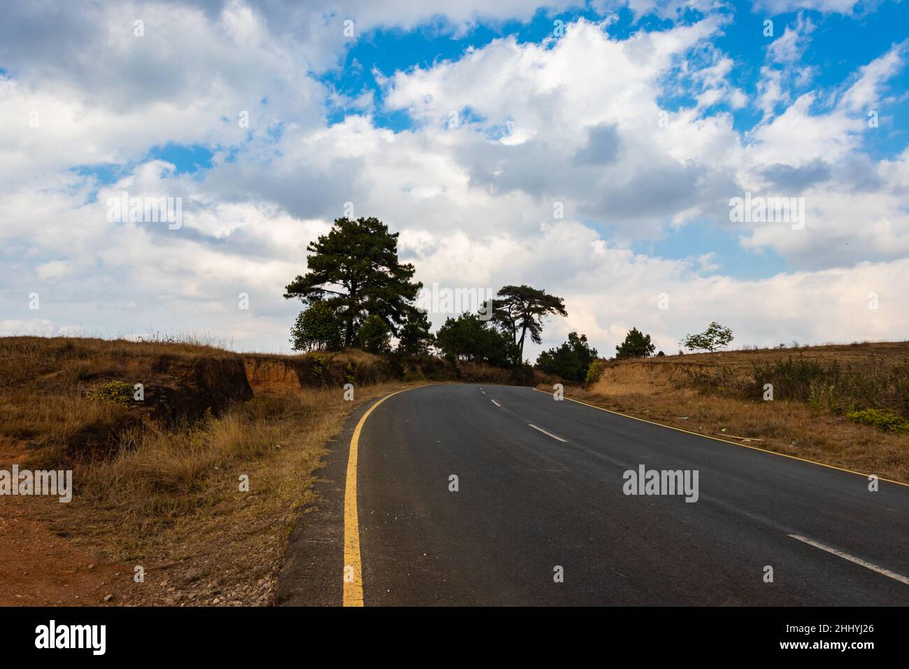 isolated countryside tarmac road with bright blue sky at morning from ...