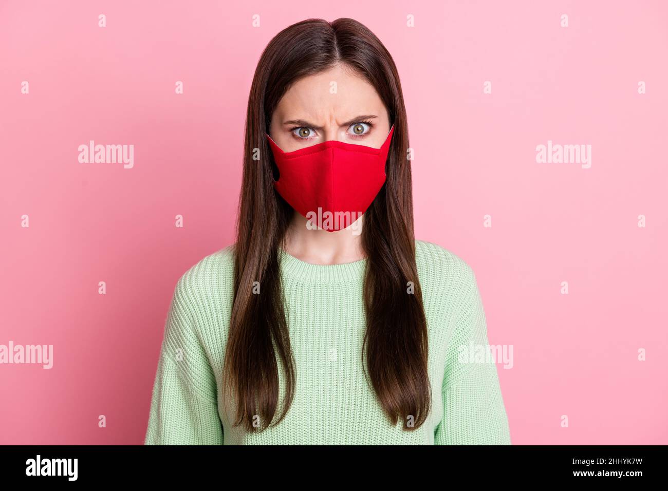 Portrait of angry brunette girl wear face mask lime sweater isolated on ...