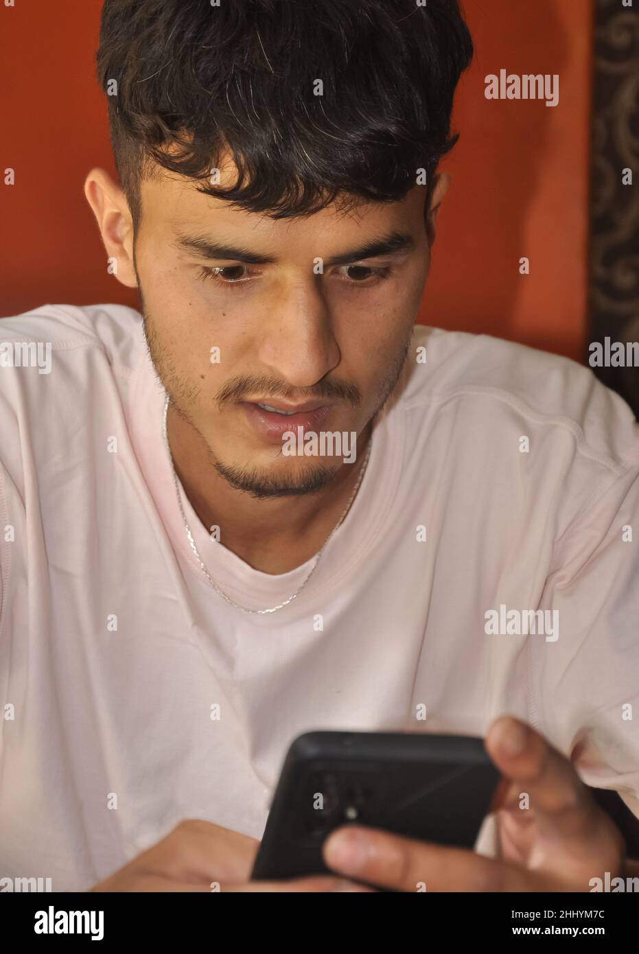 Young guy smartphone sitting hi-res stock photography and images - Alamy