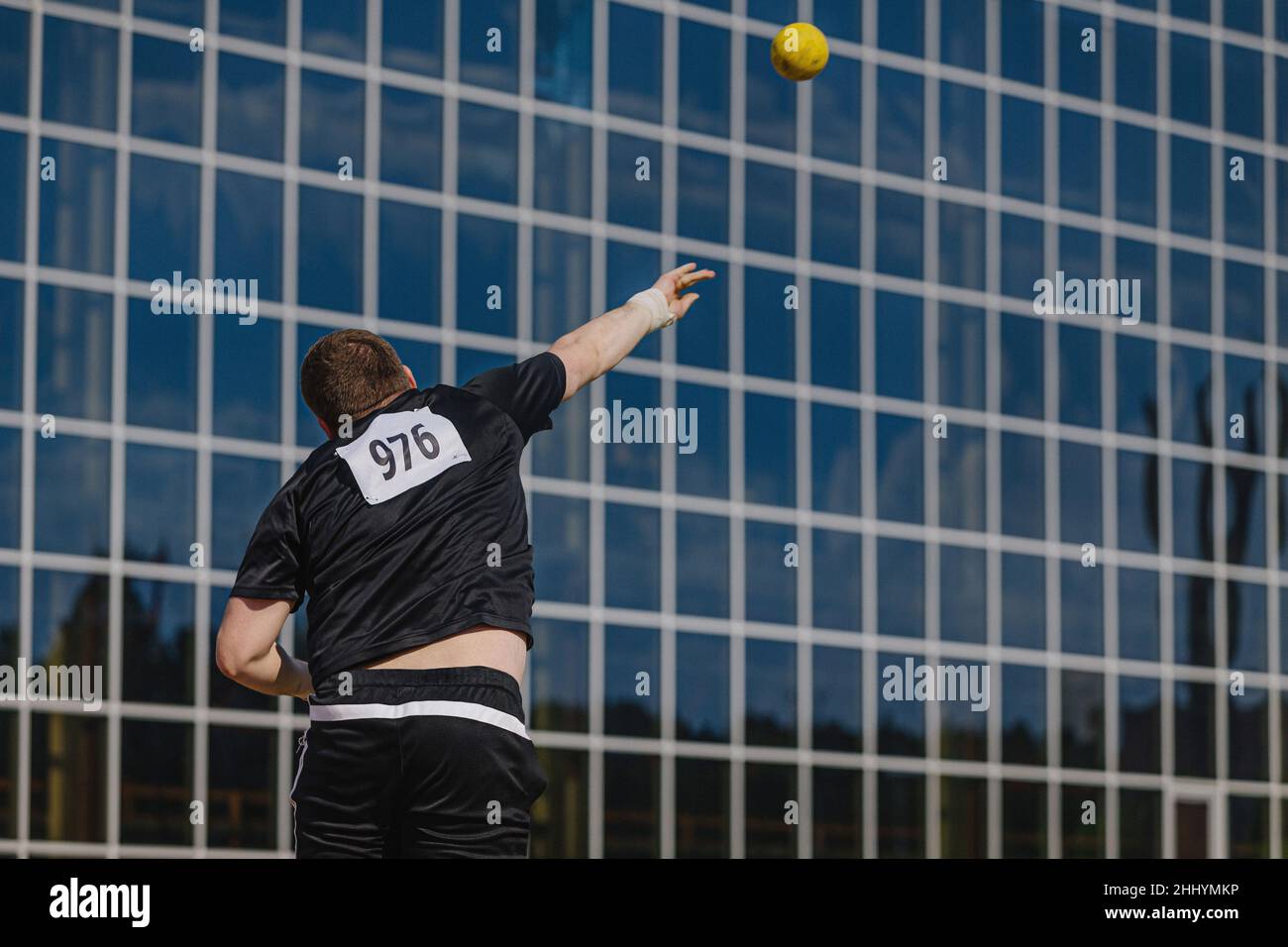 male athlete shot put on background glass facade Stock Photo - Alamy