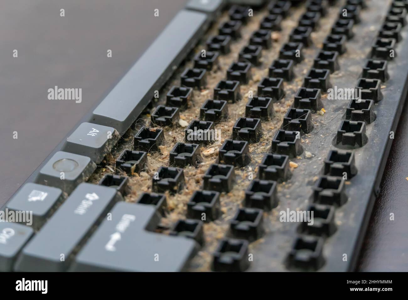 Close-up of a very dirty disassembled computer keyboard on the table ...