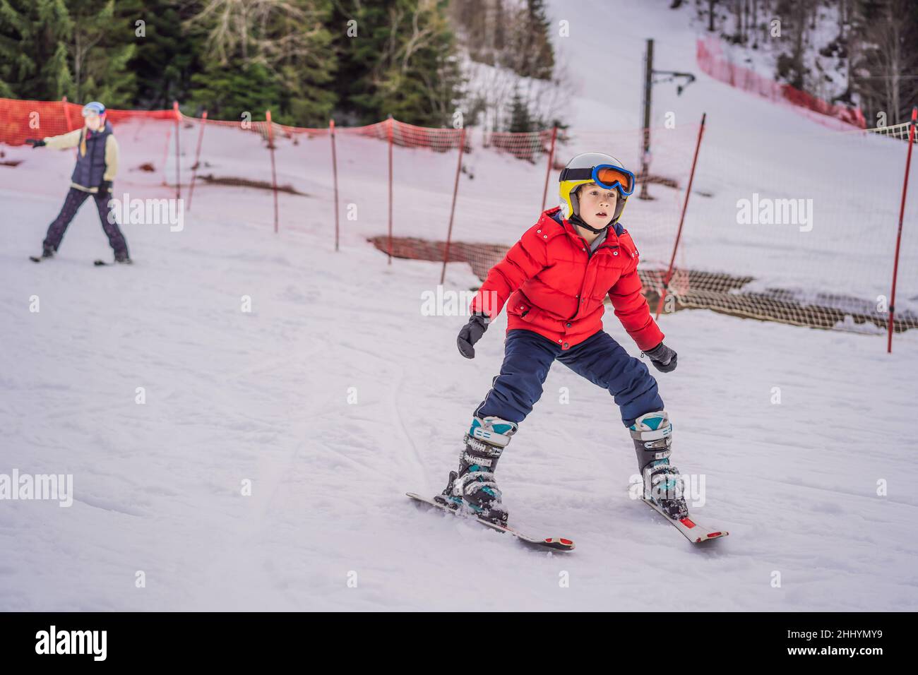 Child skiing in mountains. Active toddler kid with safety helmet ...