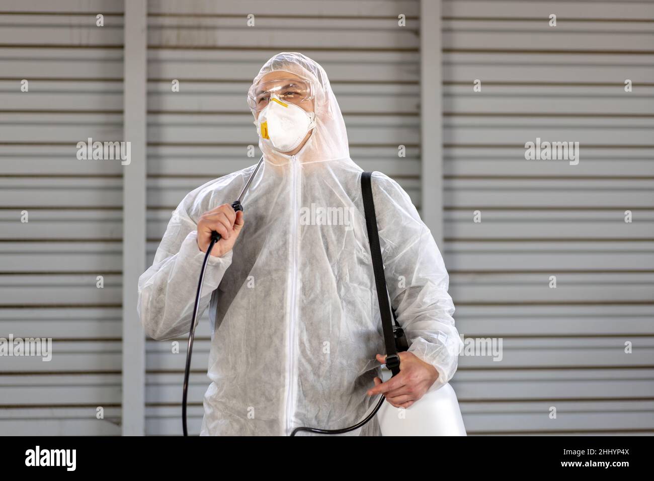 Worker wearing protective suit disinfection gear disinfect surface ...