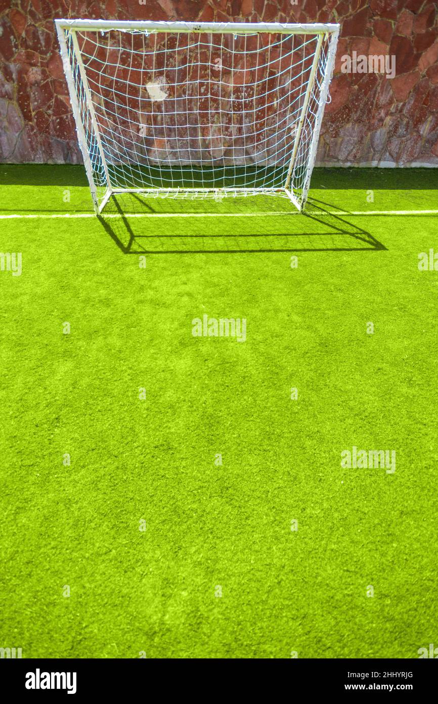 Football or soccer white goal on an amateur small field with copy space ...