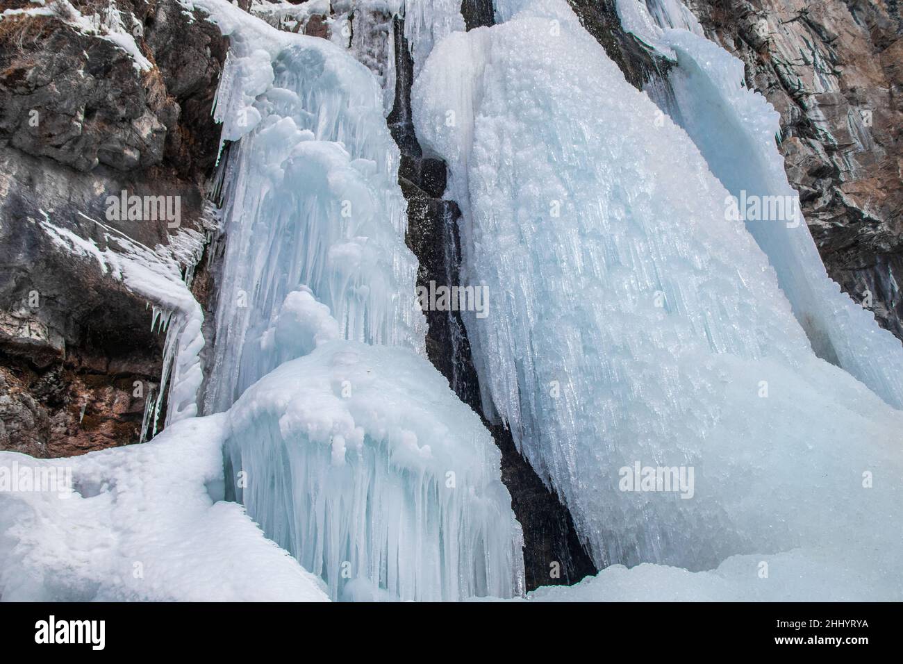 Frozen Butakov Waterfall in gorge in the suburb of the city of Almaty ...