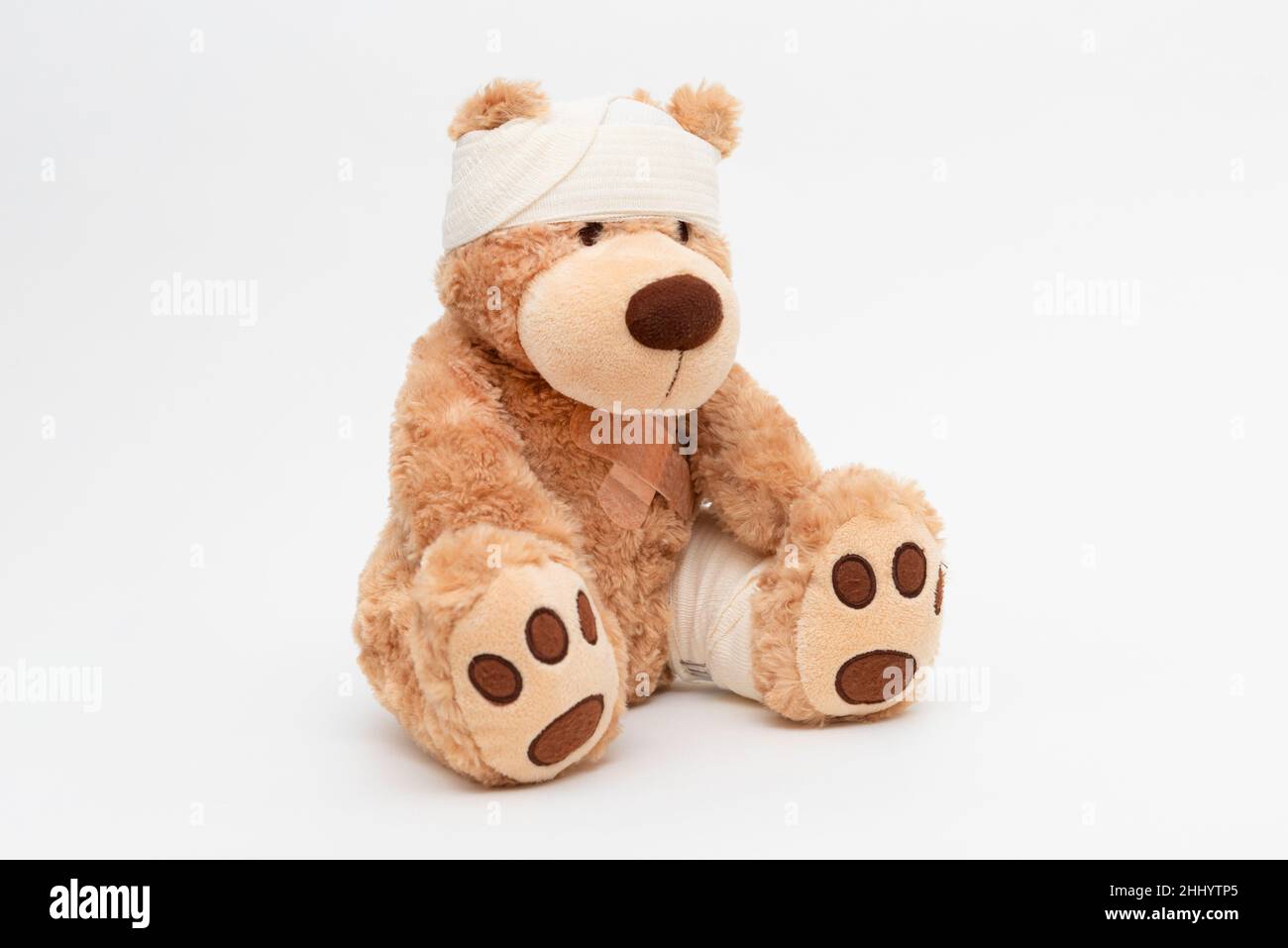 Teddy bear with bandage, child medical care concept. Bear on white ...