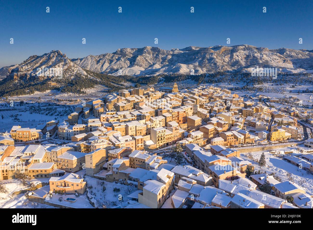 Horta de Sant Joan village aerial view in a winter snowy afternoon ...