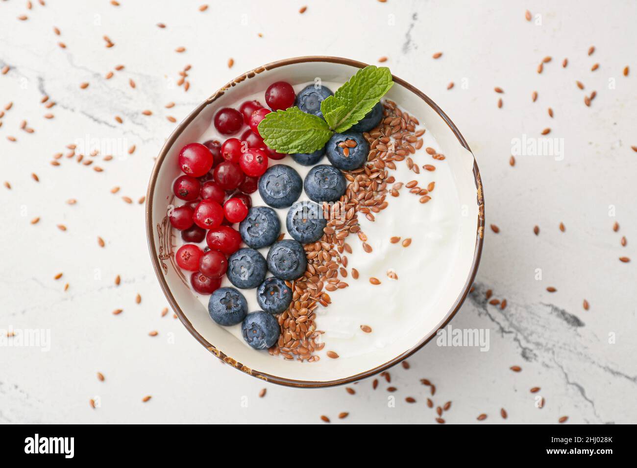 Bowl of sweet yogurt, flax seeds and berries on white background Stock ...