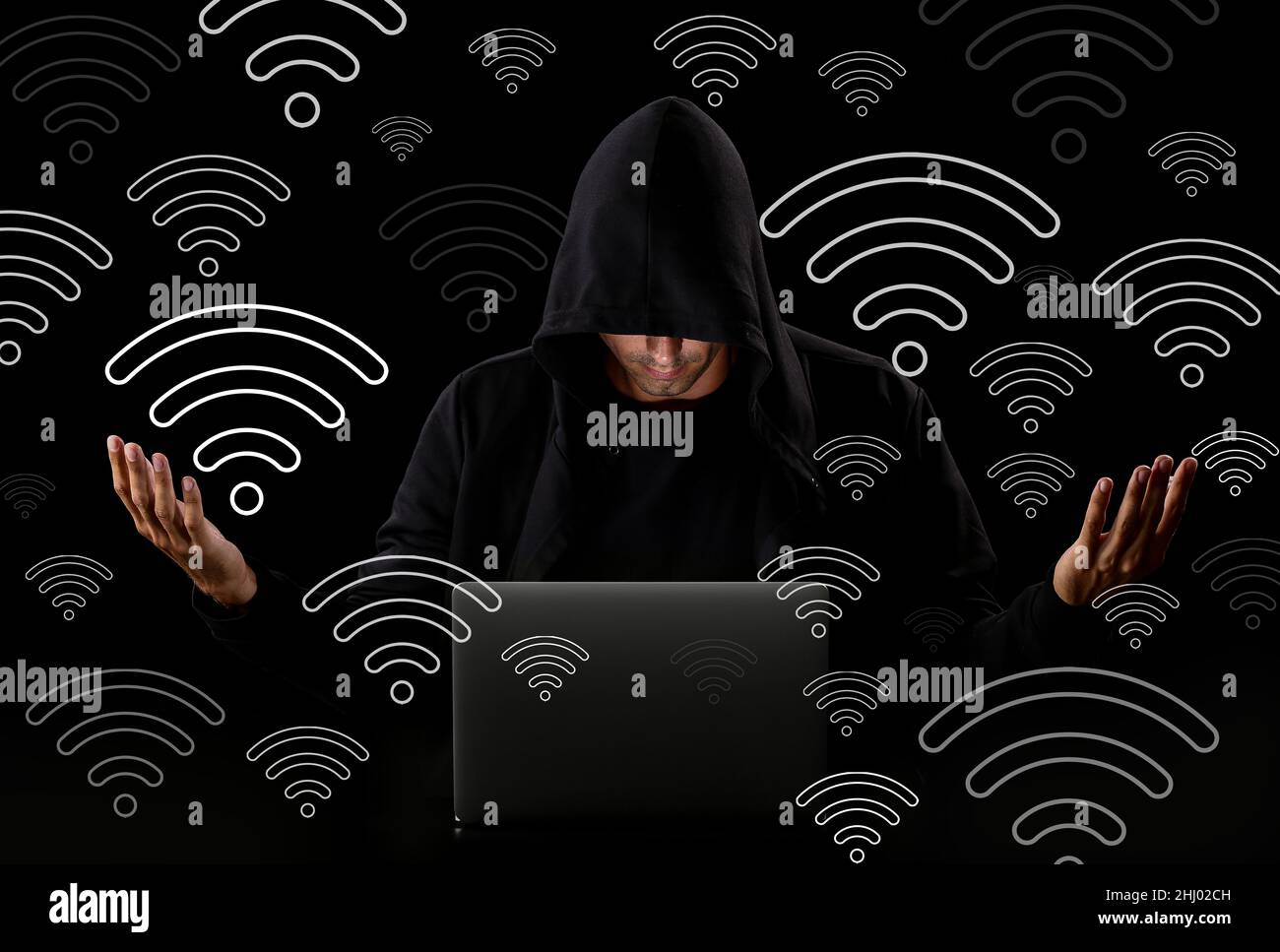 Man with laptop using wi-fi on dark background Stock Photo - Alamy