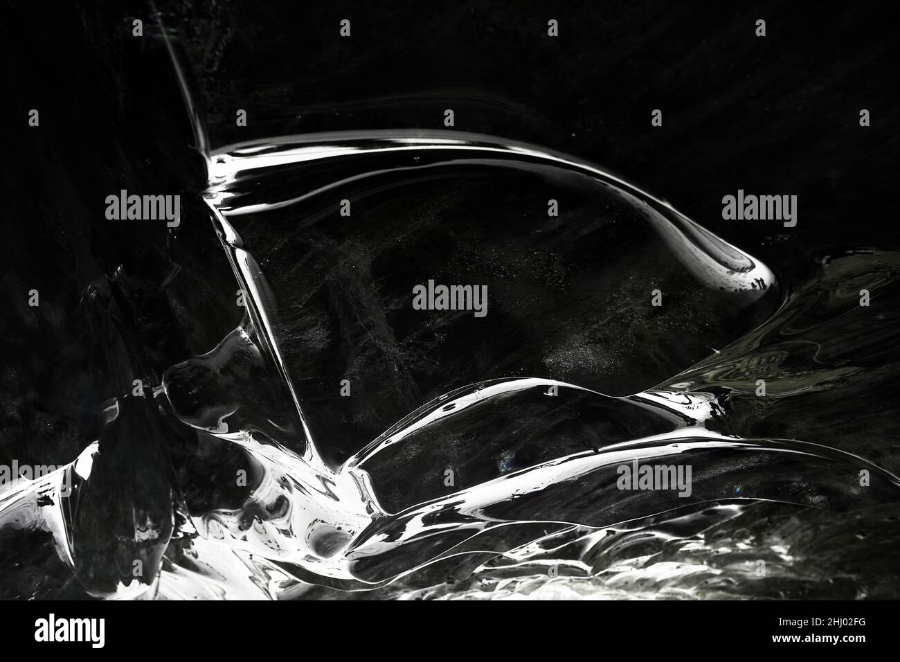 Beautiful texture triangle shape of ice cave arch in winter mountains ...