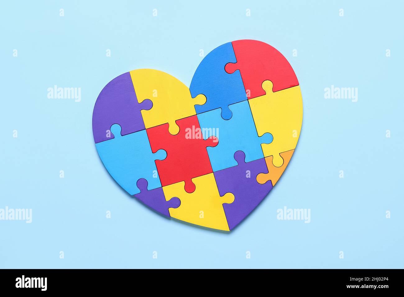 Colorful puzzle pieces in shape of heart on color background. Concept ...