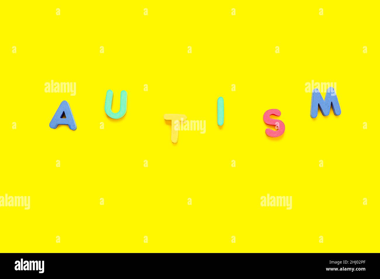 Word AUTISM on yellow background Stock Photo - Alamy
