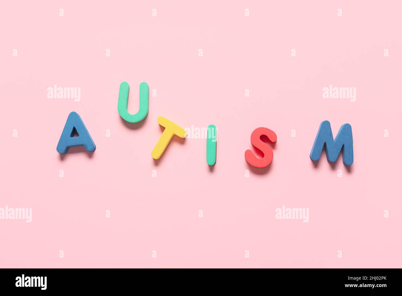 Word AUTISM on pink background Stock Photo - Alamy