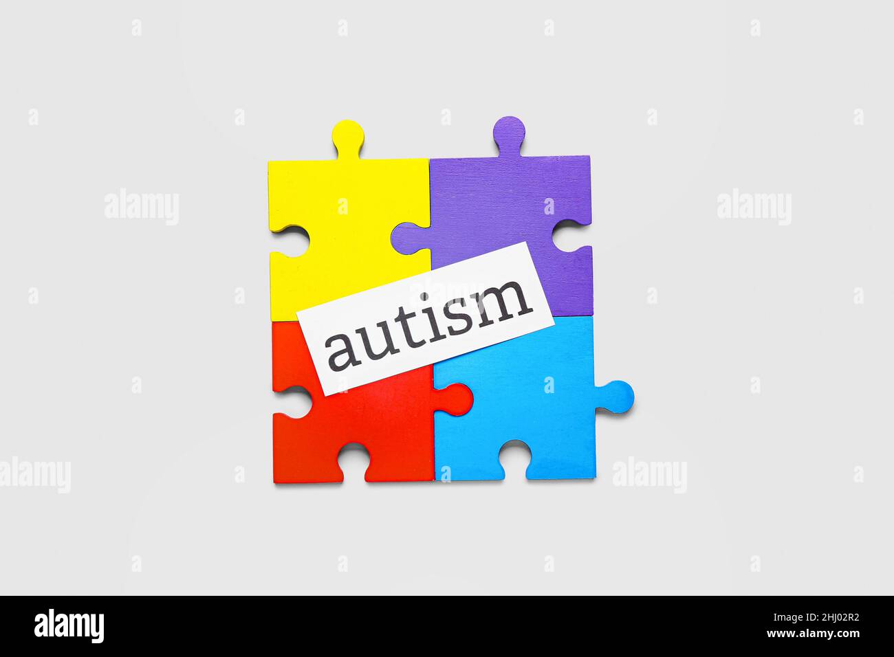 Word AUTISM with colorful puzzle pieces on light background Stock Photo ...