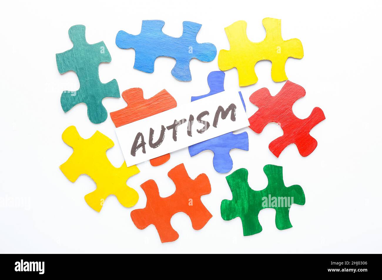 Word AUTISM with colorful puzzle pieces on white background Stock Photo ...
