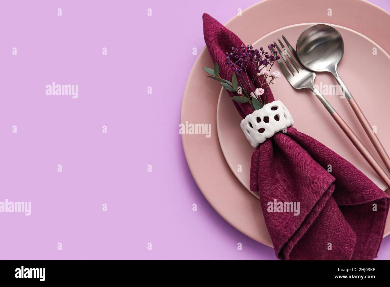 Stylish table setting on purple background Stock Photo - Alamy