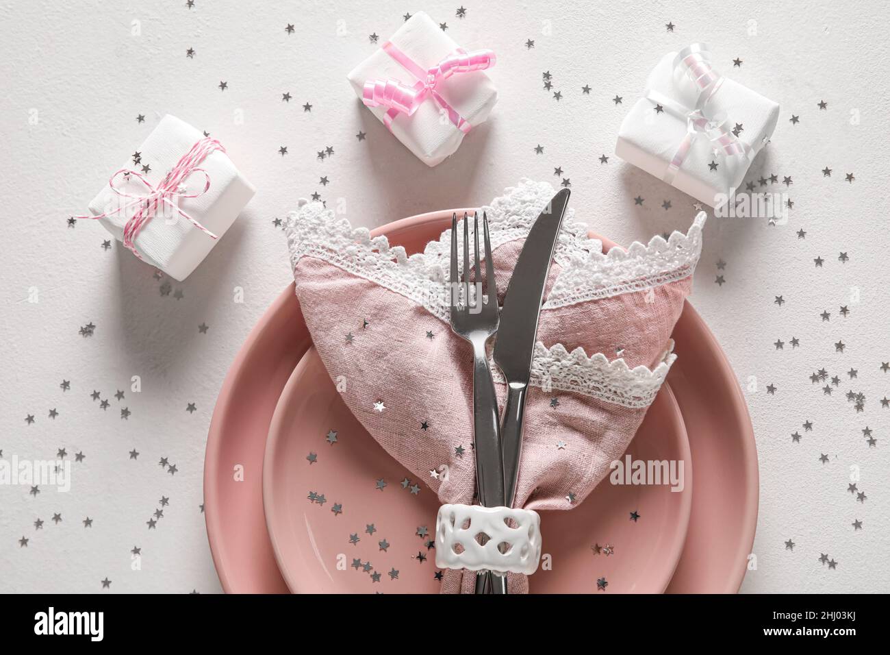 Stylish table setting and gift boxes on light background Stock Photo ...