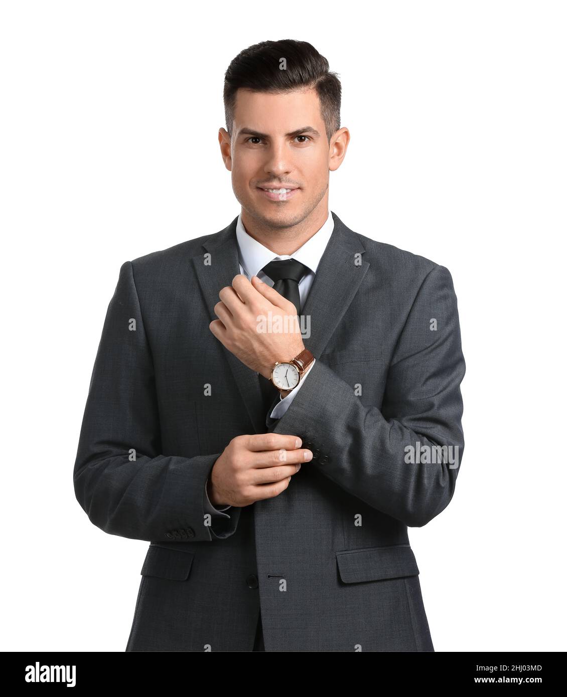 Handsome man in formal suit adjusting sleeve on white background Stock ...