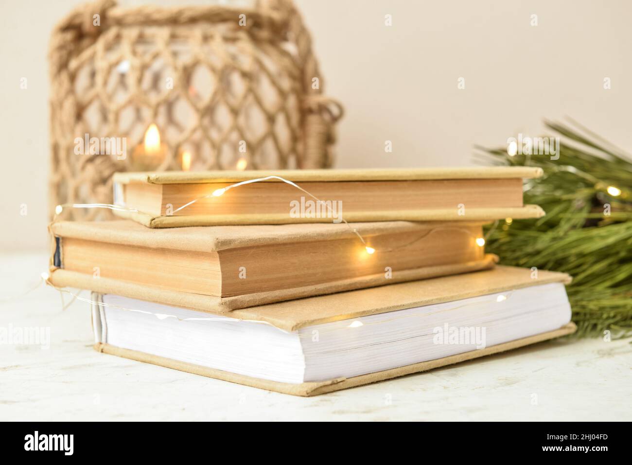 Stack of books with glowing lights on table, closeup Stock Photo - Alamy