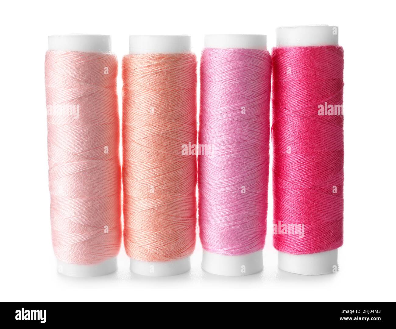 Multicolored sewing thread spools on white background Stock Photo - Alamy