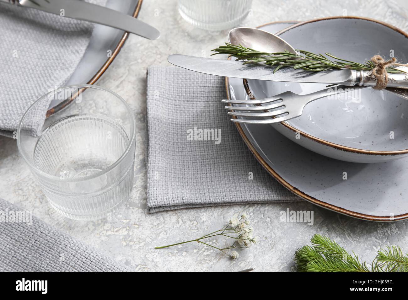 Elegant table setting with floral decor on light background Stock Photo ...