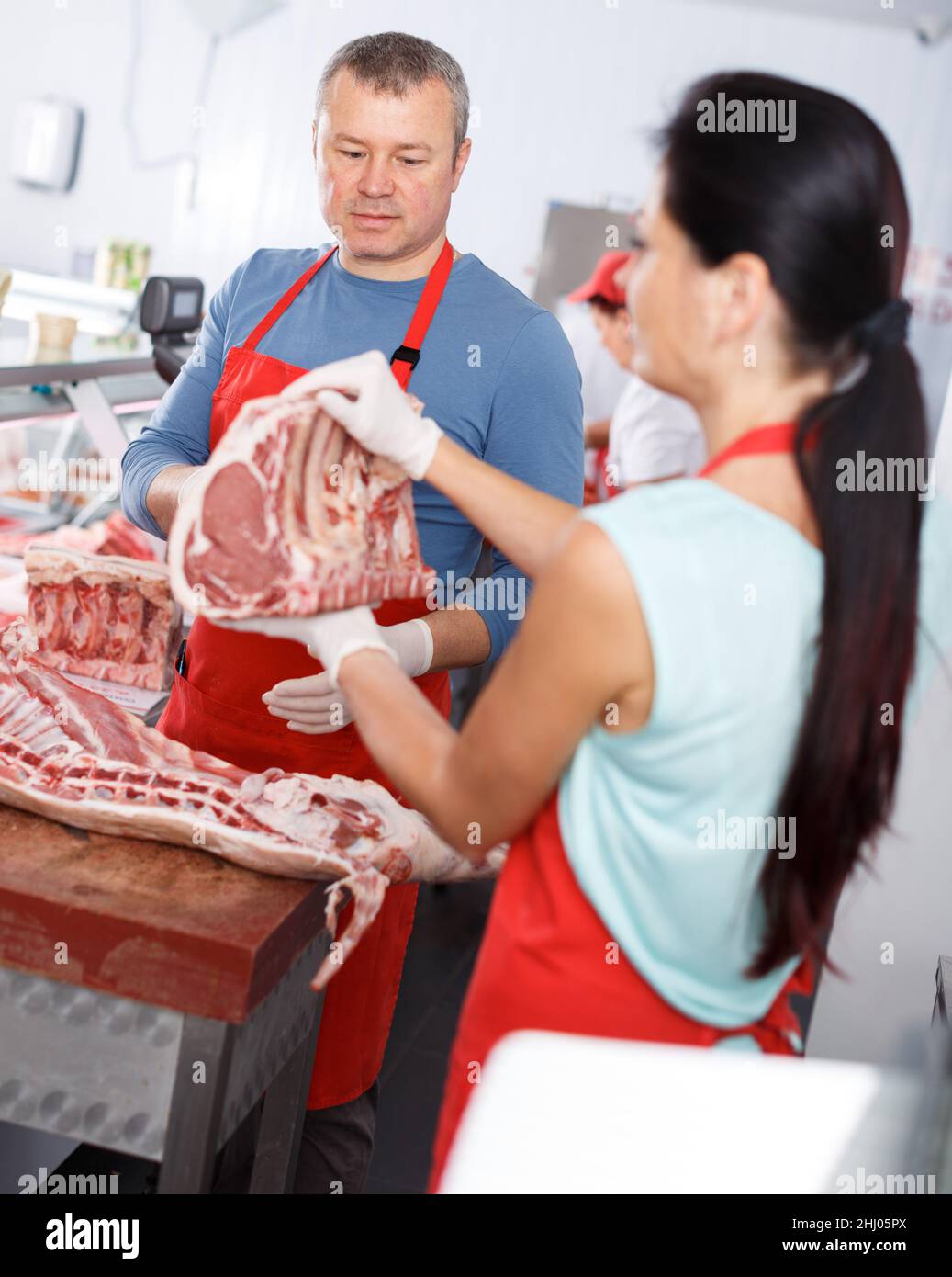 Positive sellers discussing of quality meat Stock Photo - Alamy