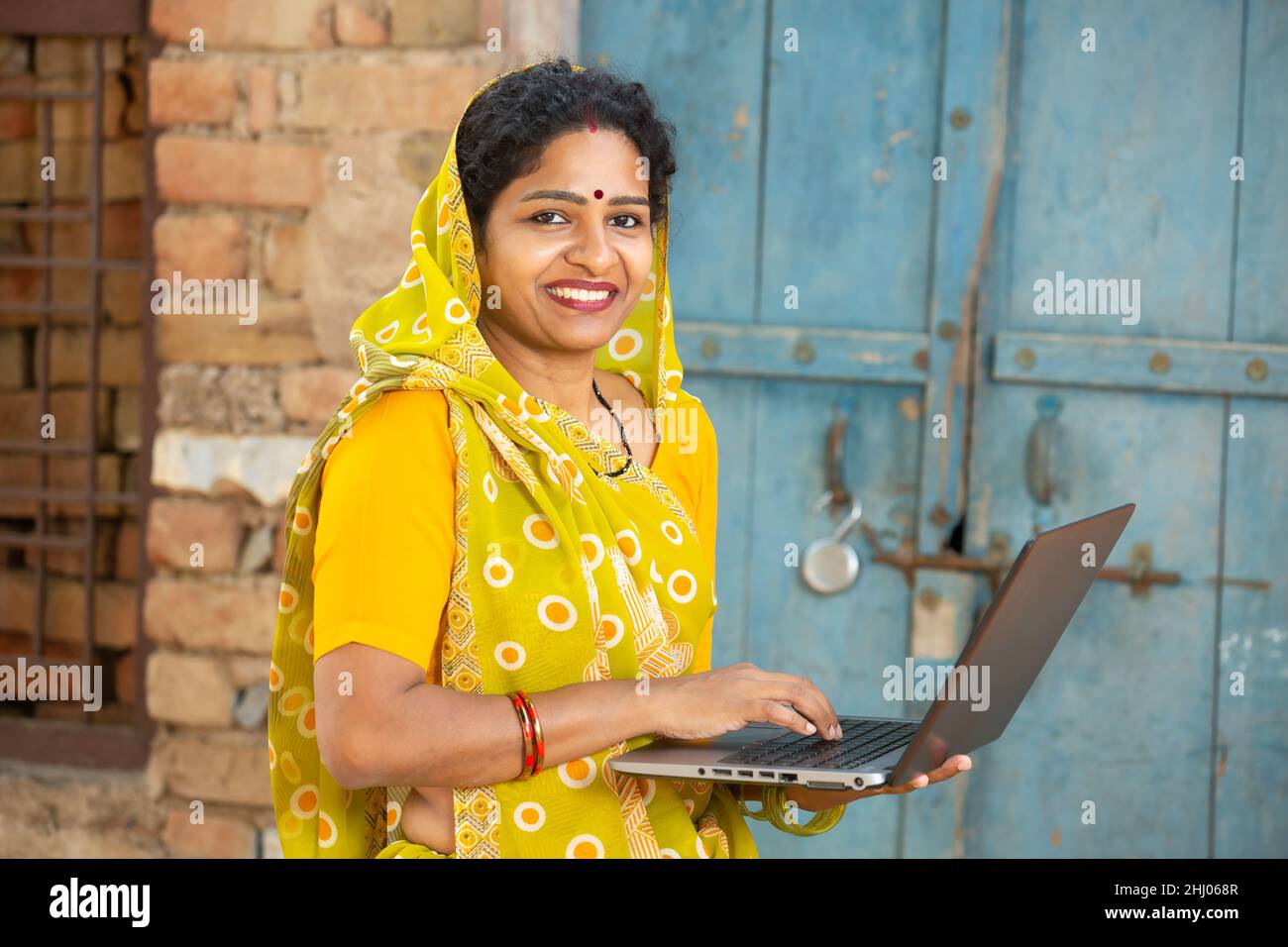 Portrait of Happy young indian woman using laptop. Smiling female ...