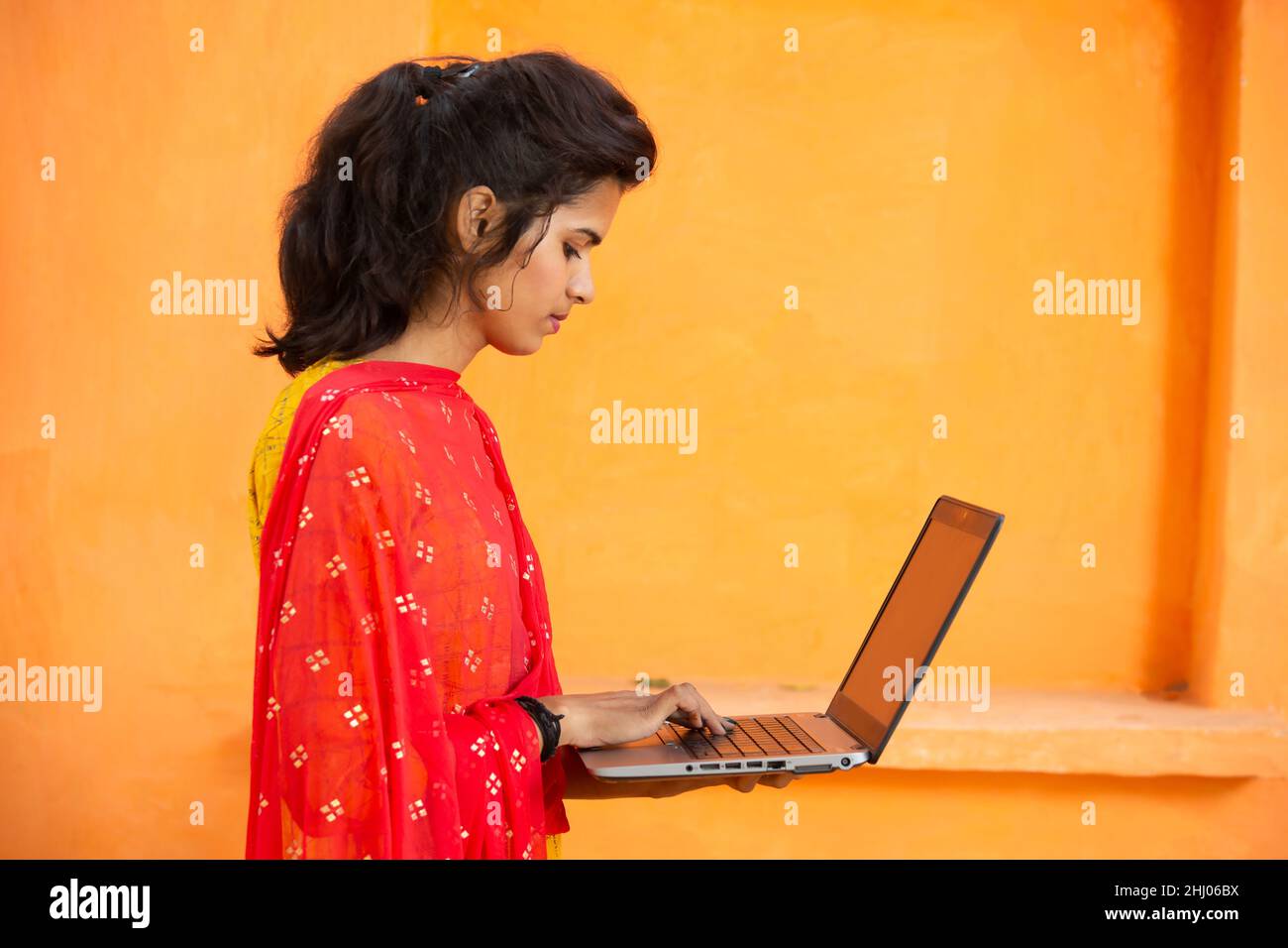 Young indian woman using laptop. female wearing traditional cloths ...