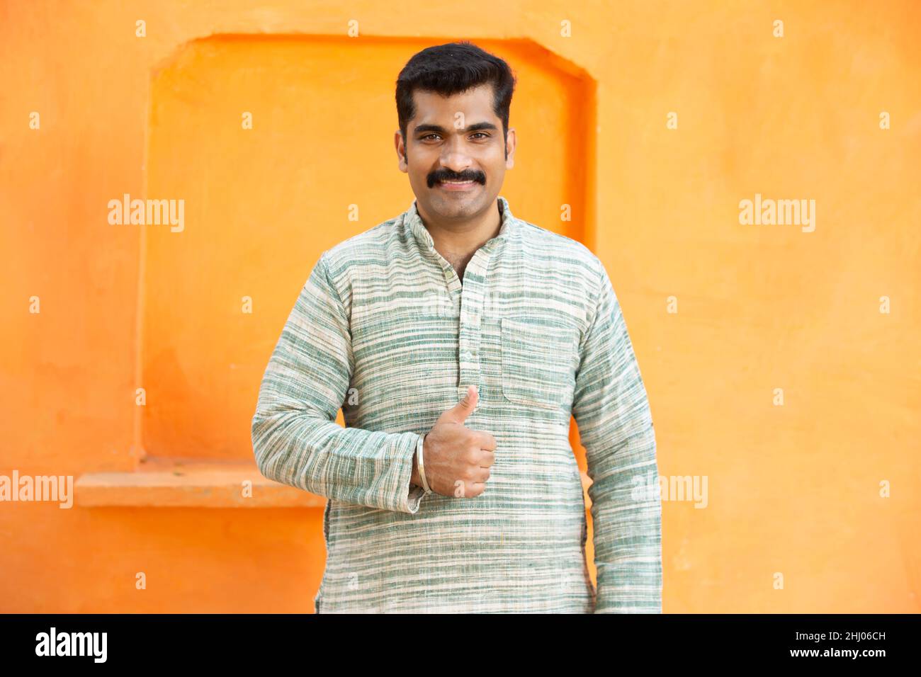 Portrait of happy indian mustache man wearing traditional kurta do ...