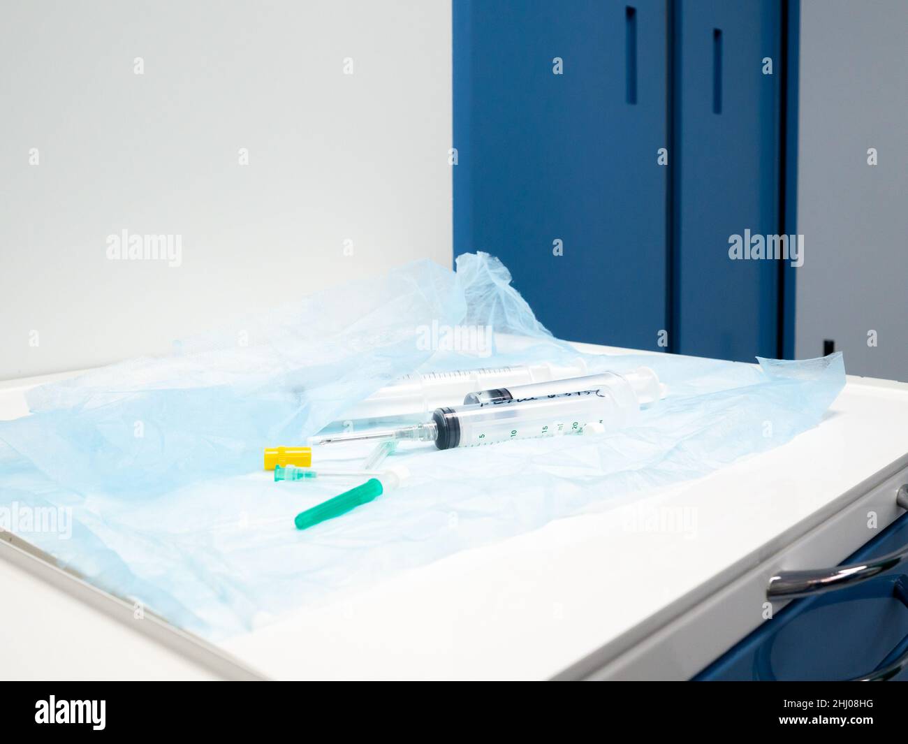 Several syringes are on the table in the hospital. Sterile medical ...