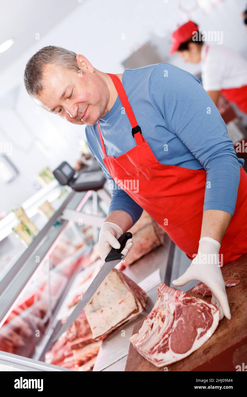 Smiling male seller cutting hi-res stock photography and images - Alamy