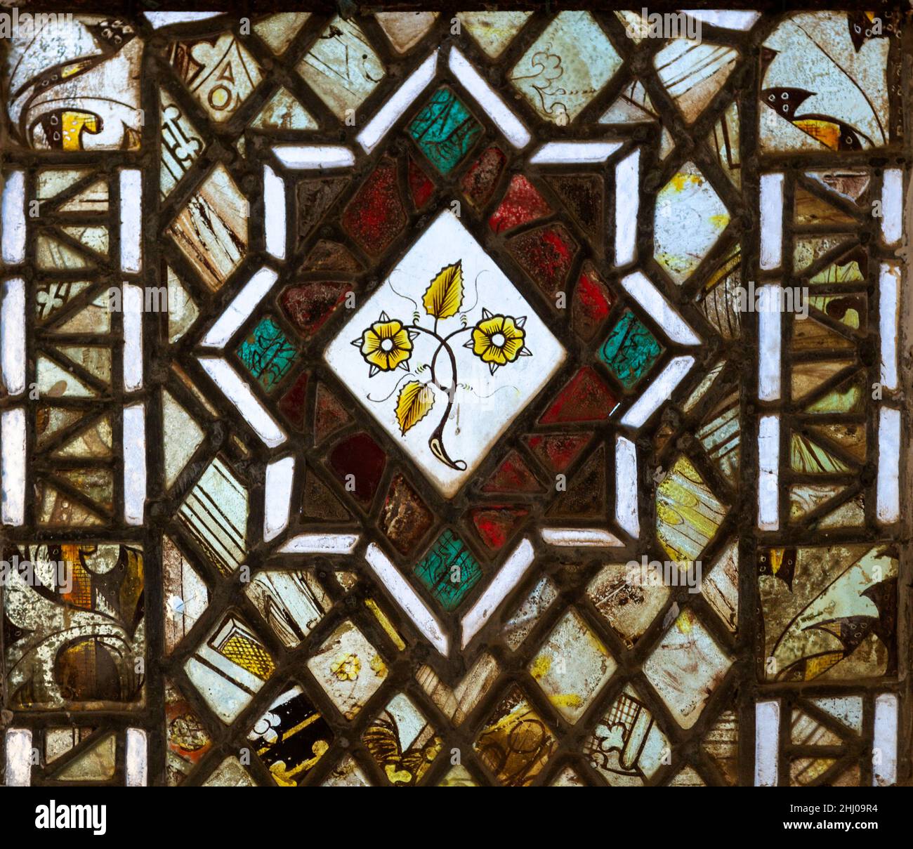Stained glass window of medieval fragments with primrose flower, Oakley ...
