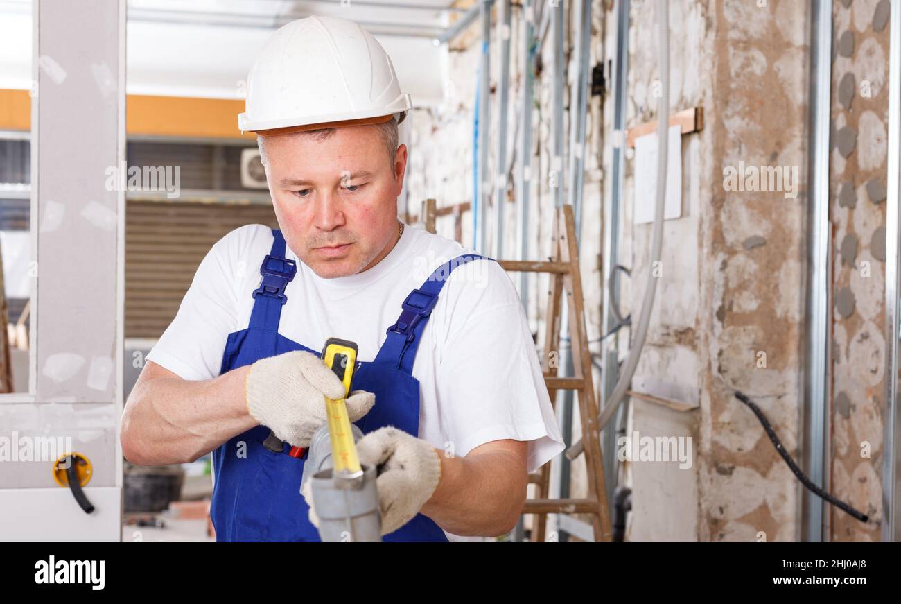 Plumber working with plastic pipes Stock Photo - Alamy