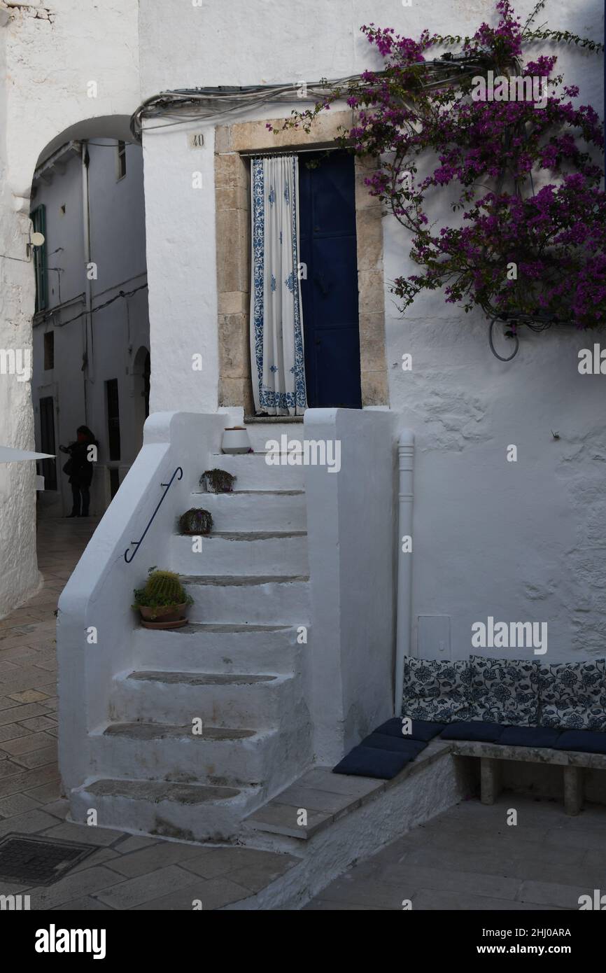 The entrance steps of an old house inside the old town of Ostuni, also ...