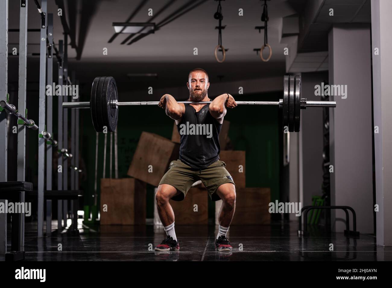 Muscular athlete lifting very heavy barbell Stock Photo - Alamy