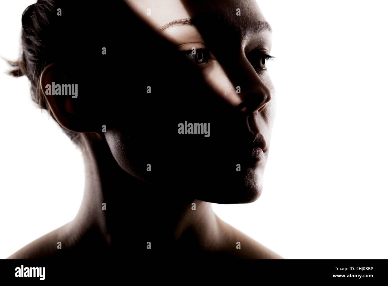 Fashionable studio portrait of a cute girl. Silhouette of a beautiful ...