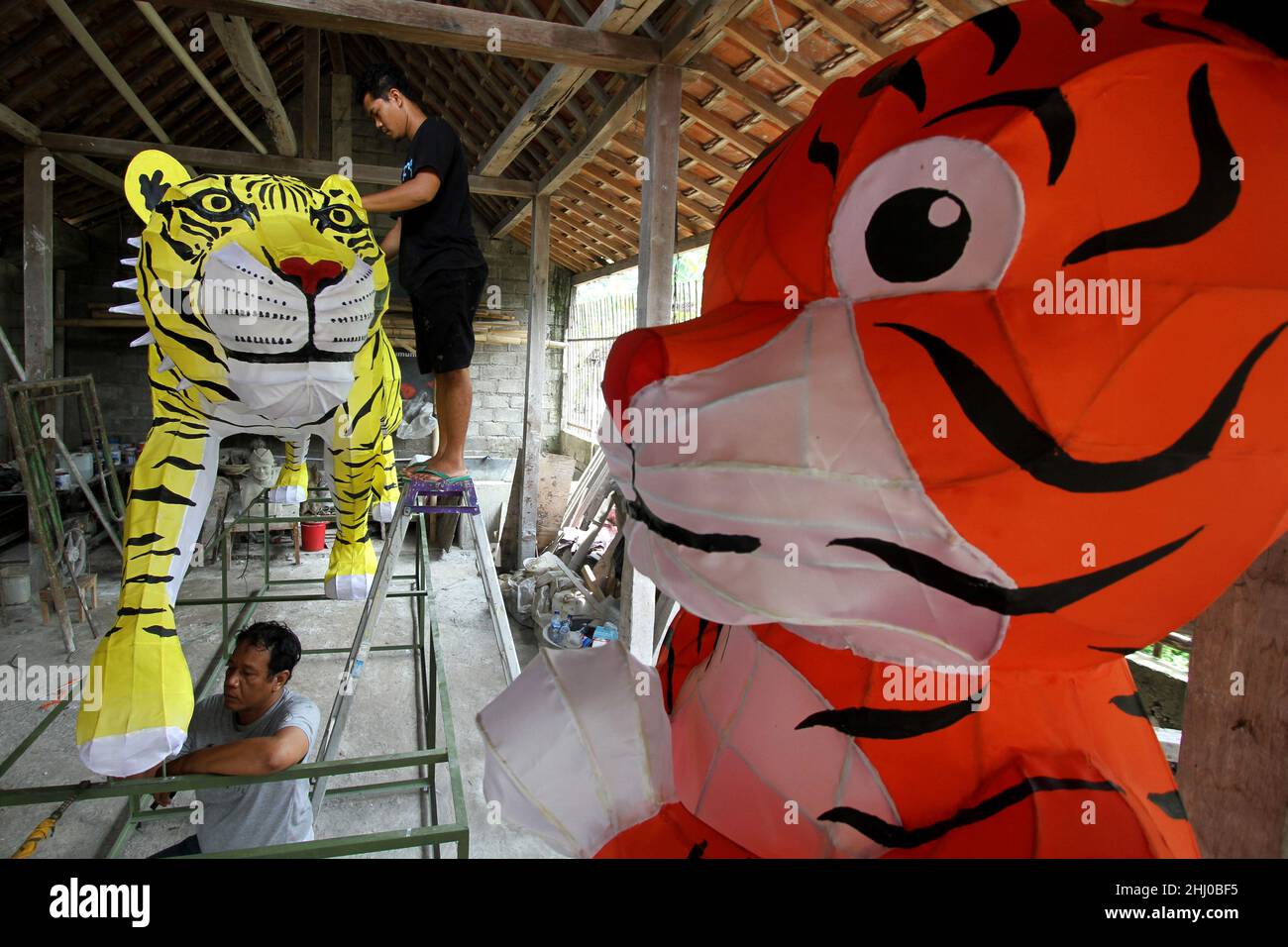 Surakarta, Indonesia. 26th Jan, 2022. Workers make a tiger lantern for ...