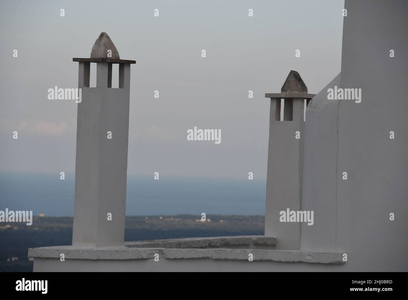 Two chimneys inside the old town of Ostuni, also known as "The white ...