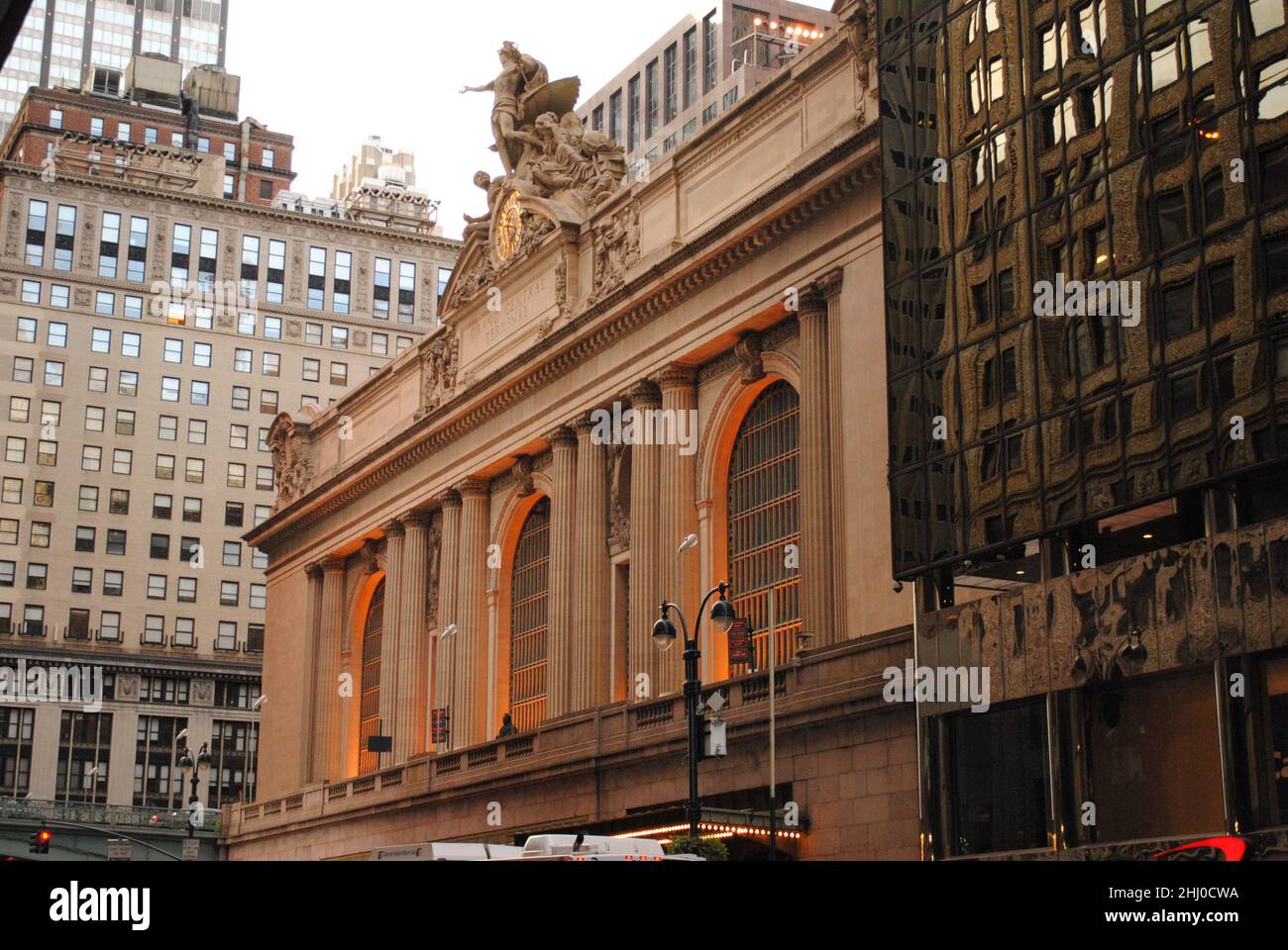 Side view of a building in New York business street with lights on ...