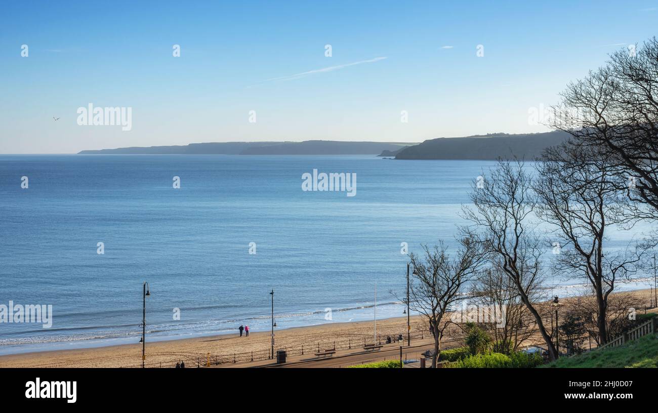 Panoramic view of a seaside bay. Cliffs are on one side stretching to ...