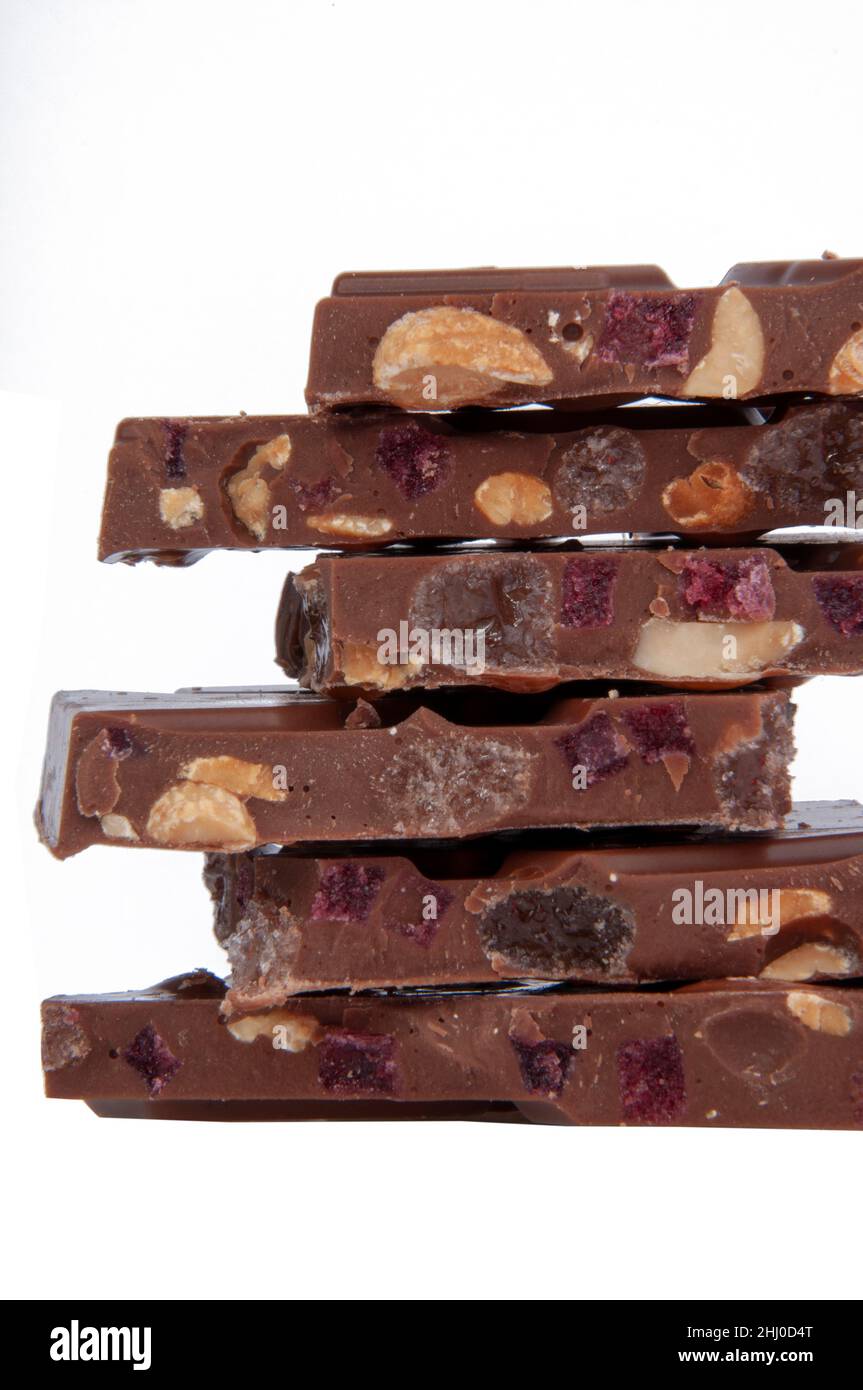 milk chocolate with nuts and berries brocken isolated on the white ...