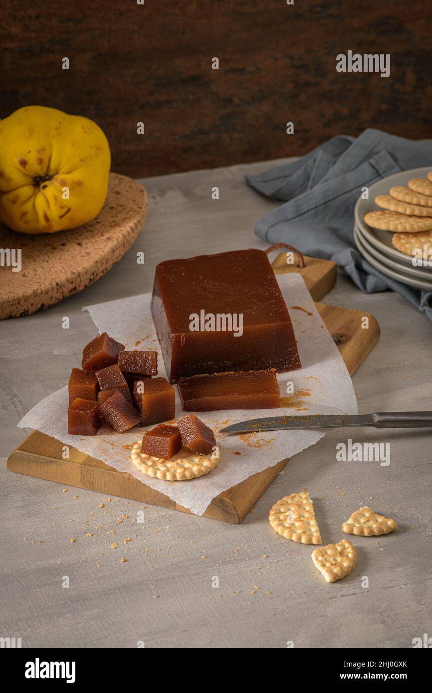 Marmalade in crackers on a kitchen counter with quinces on a cork tray ...