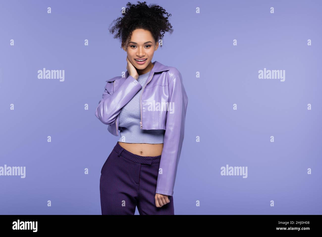cheerful african american woman in violet leather jacket smiling ...