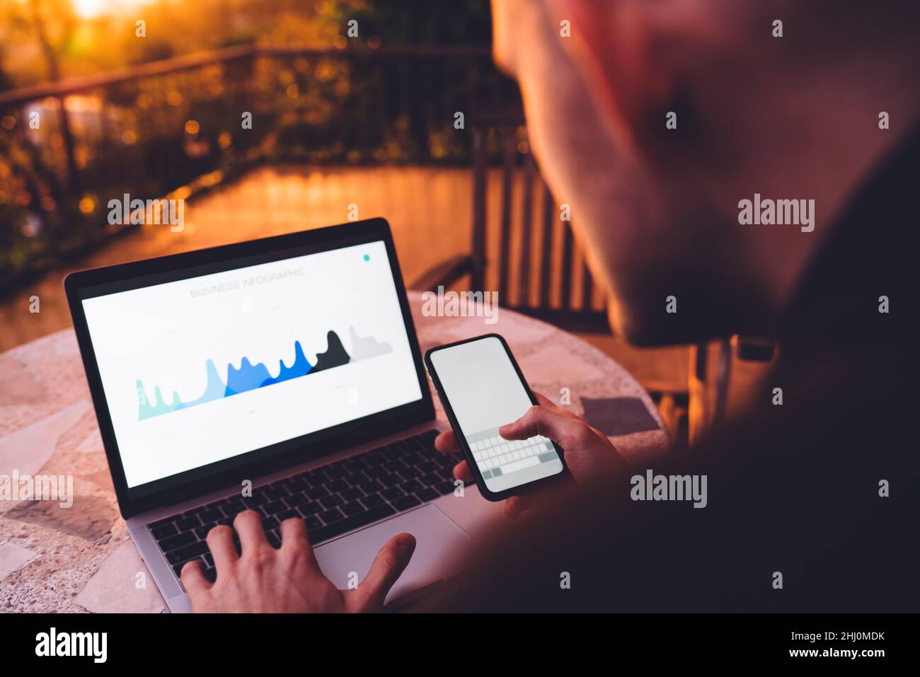business man using wireless internet connection on netbook and mobile ...